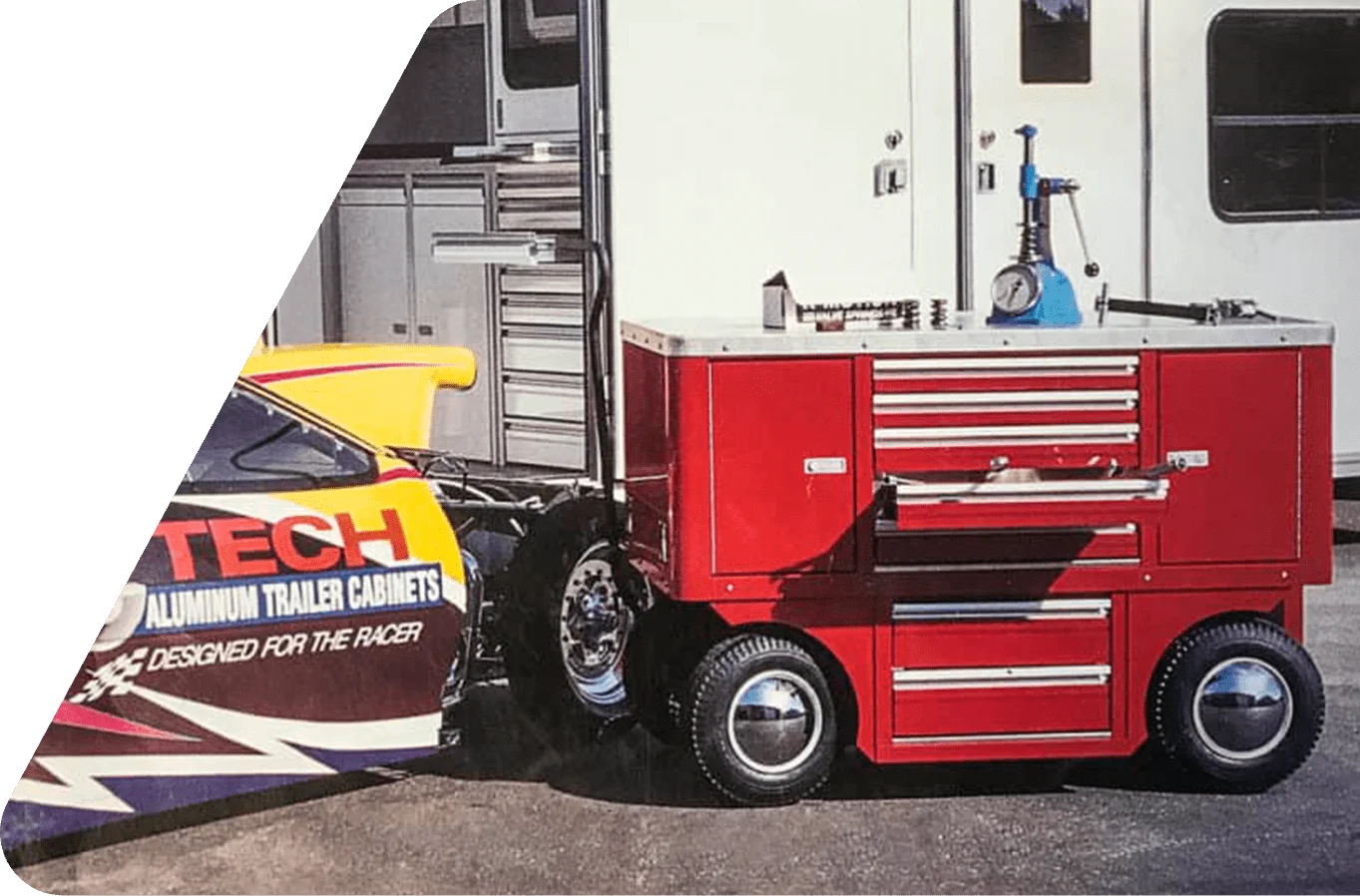 red car parked in front of red metal cabinets